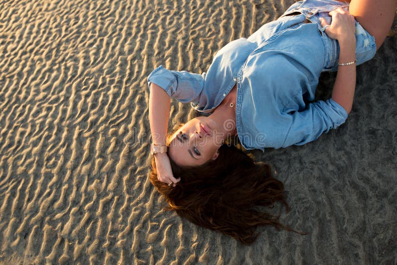 Young Girl Lying on the Sand at Sunset. Stock Image - Image of model ...