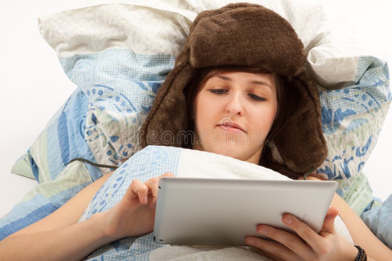 The Girl is Lying Sick in Bed and Looking into Her Tablet Stock Photo ...