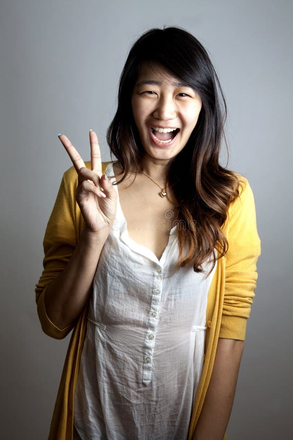 A Young Girl Making a Peace Sign. Stock Image - Image of teeth ...
