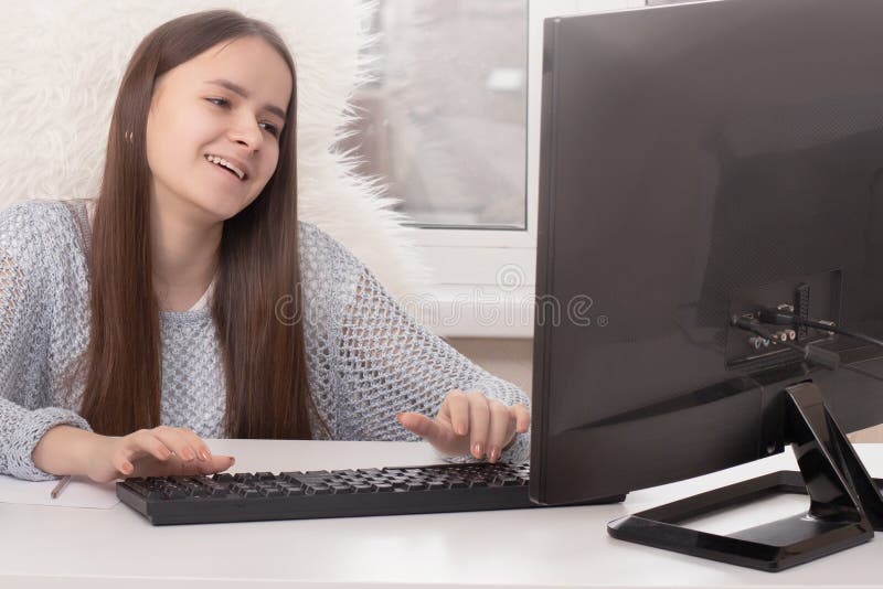Young Girl Manager Works at Home Remotely at the Computer during ...