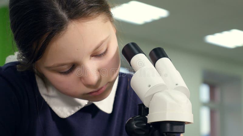 Young Girl with Microscope in School Research Lab Looking into ...