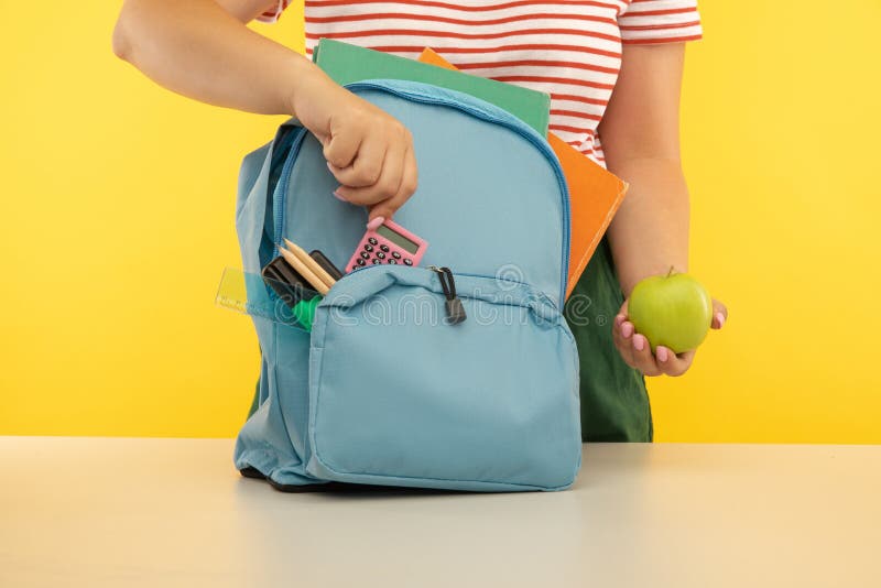 Young Girl Packing Blue Backpack. Back To School Concept Stock Photo ...