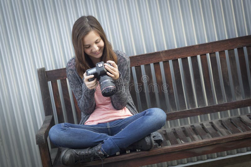 Young Girl Photographer Looking at Back of Camera Stock Photo - Image ...