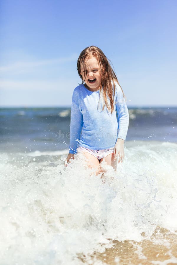 Young Girl Playing on the Beach in Waves at Summer Stock Image - Image ...