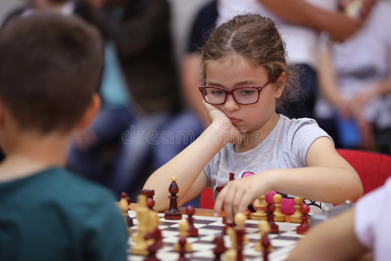 Young girl playing chess editorial photography. Image of education ...