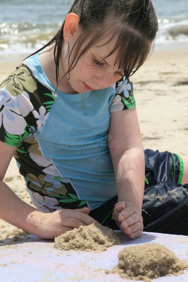Young Girl Playing in the Sand Stock Image - Image of summer, outdoors ...