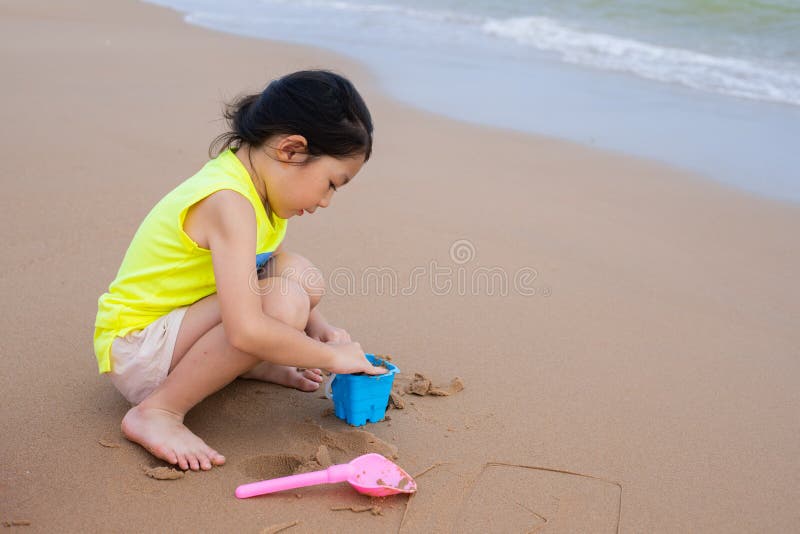 A Young Girl Playing Sand at the Beach Stock Photo - Image of happy ... A Young Girl Playing Sand at the Beach Stock Photo - Image of happy ...