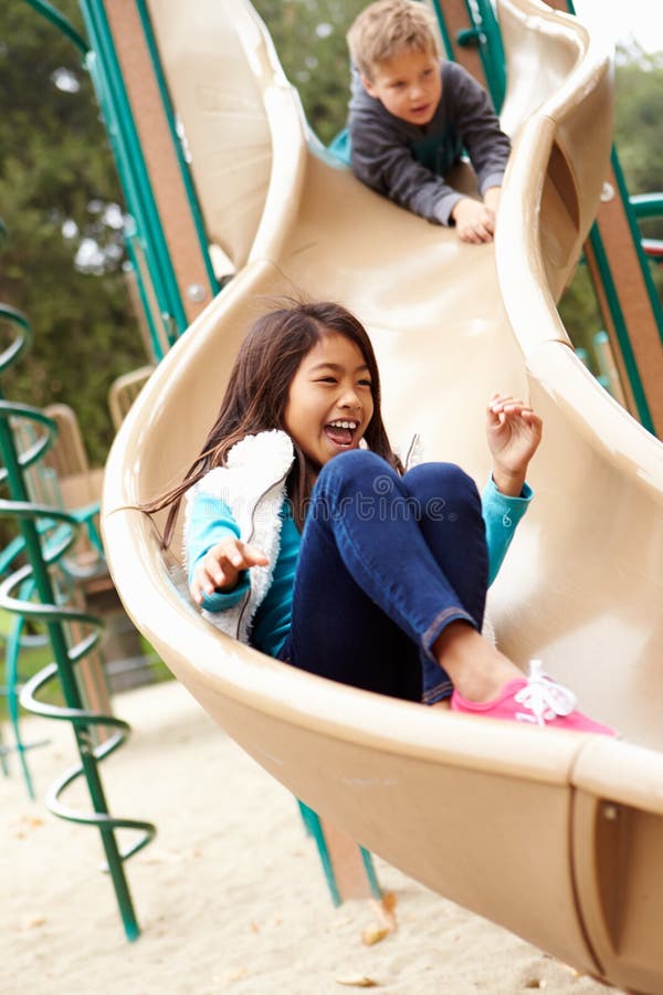 Young Girl Playing on Slide in Playground Stock Photo - Image of people ...