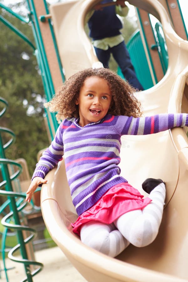 Young Girl Playing on a Slide at the Park Stock Image - Image of ...