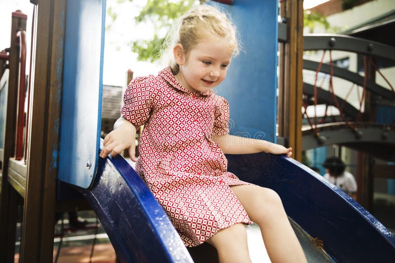 Young Girl Playing on a Slide at the Park Stock Image - Image of ...