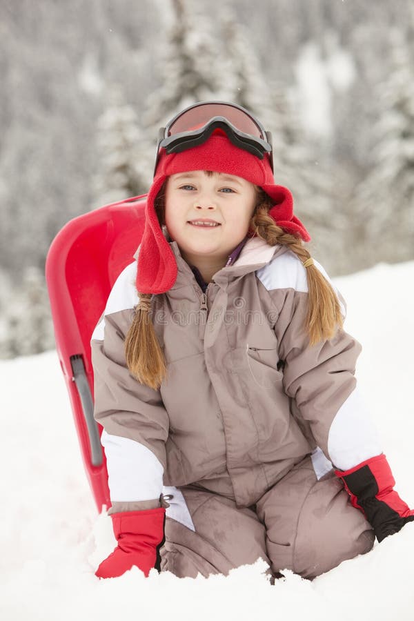 Young Girl Playing in Snow with Sledge Stock Image - Image of snow ...