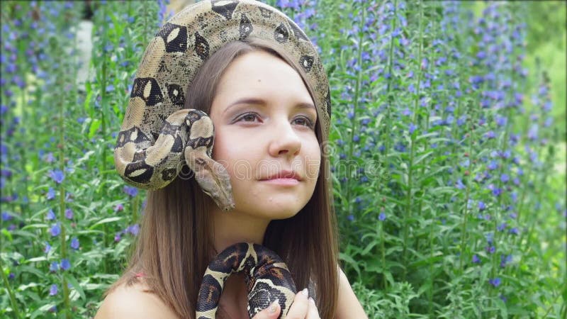 Young Girl Posing with a Snake Around His Neck on the Nature Stock ...