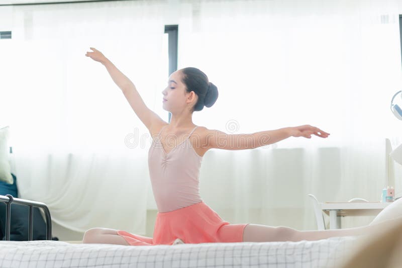 A Young Girl Practices Her Stretching Routine in Bedroom before ...