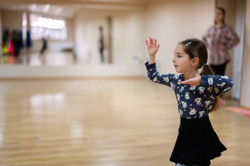 Young Girl Practicing Dance Moves in a Studio with Instructor in ...