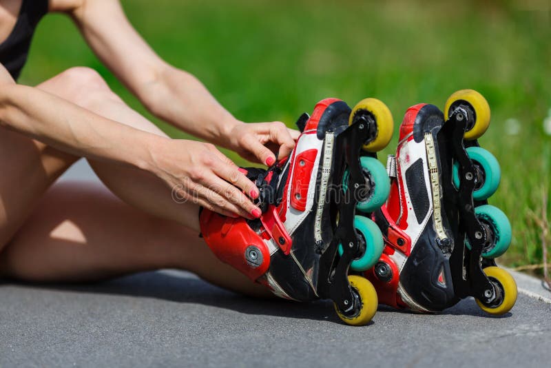Young Girl Putting on Inline Skates Stock Photo - Image of female ...