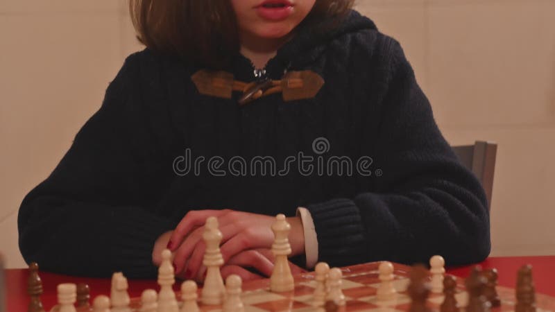 Young Girl Reaching while Playing Chess Stock Video - Video of indoor ...