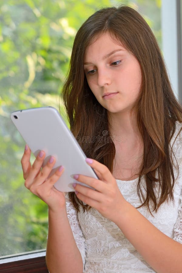 Young Girl Reading Information on a Tablet Computer Stock Image - Image ...