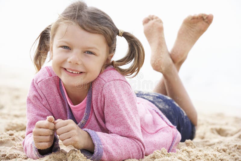 Young Girl Relaxing on Beach Stock Photo - Image of autumn, laughter ...