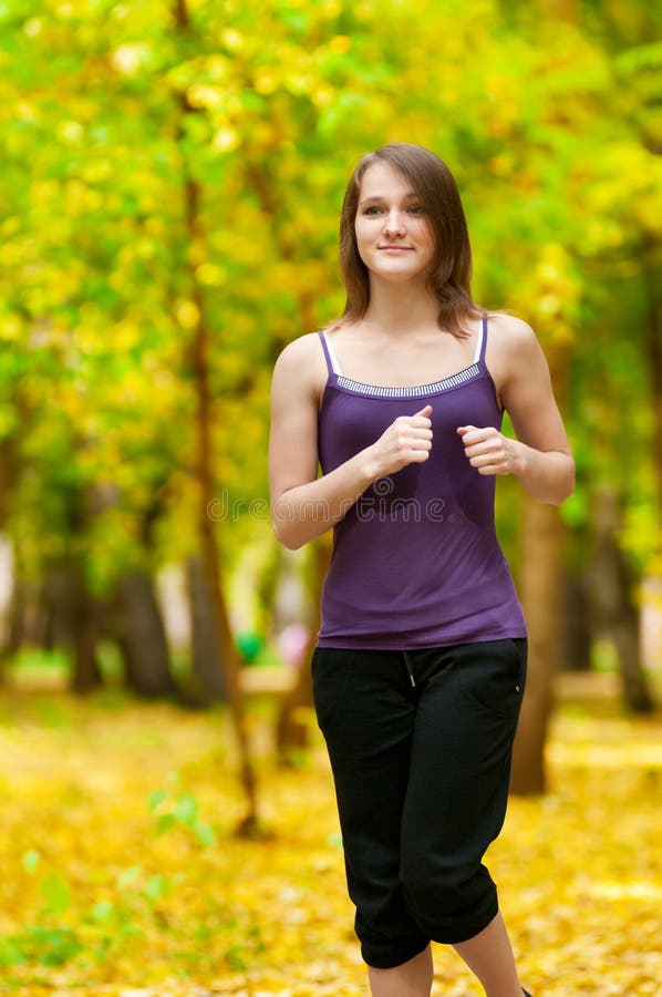 A Young Girl Running in Autumn Park Stock Image - Image of motion ...