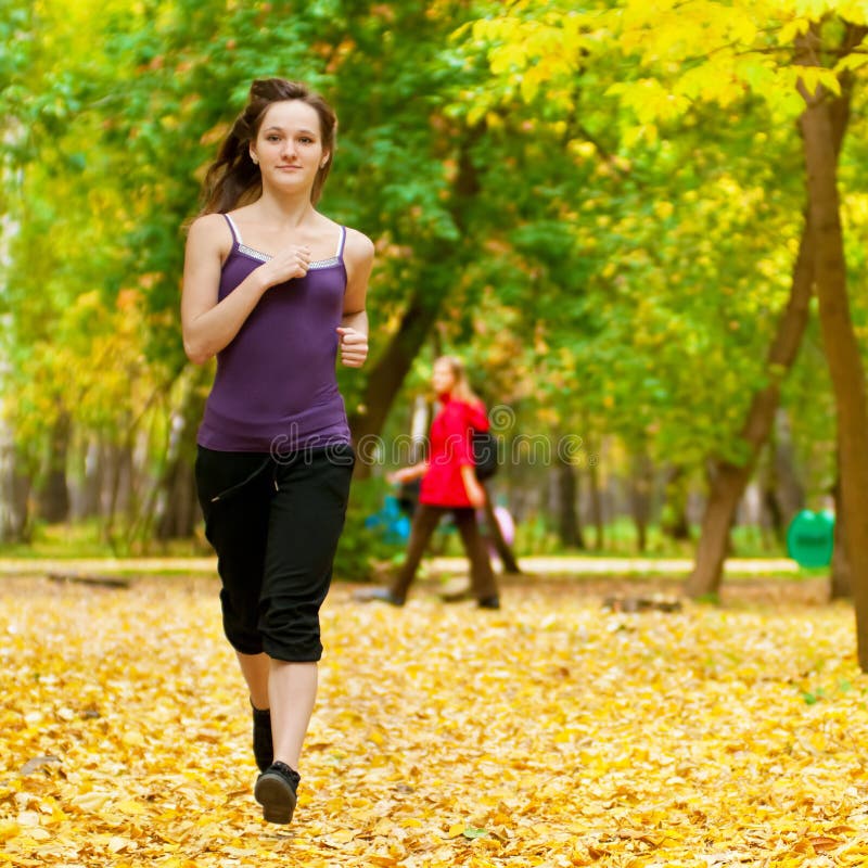 A Young Girl Running in Autumn Park Stock Image - Image of autumn ...