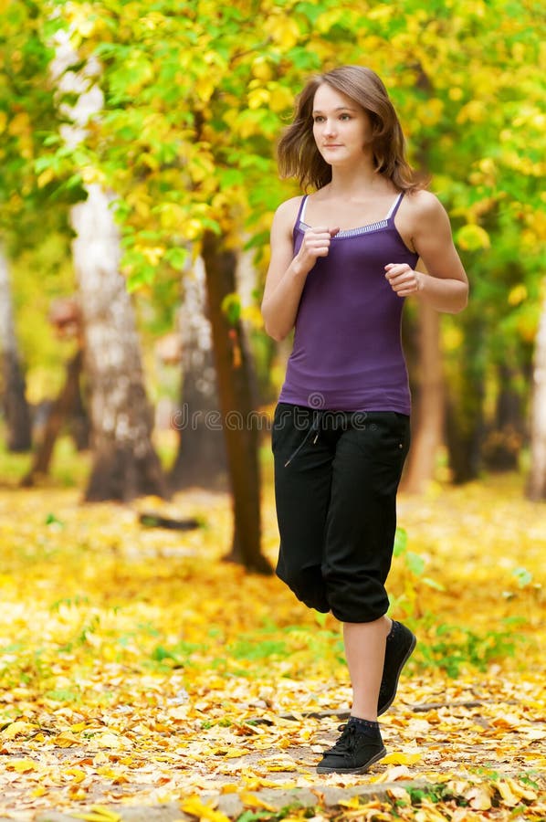 A Young Girl Running in Autumn Park Stock Image - Image of leisure ...