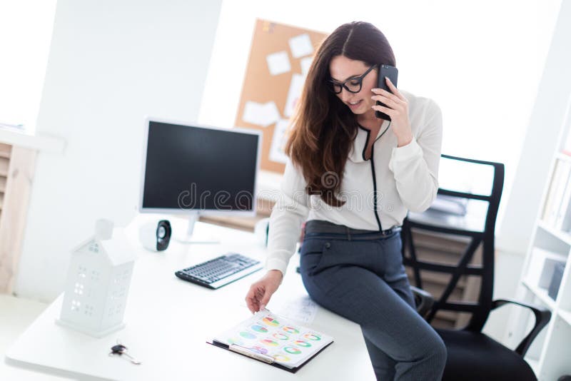 The Young Girl Sat Down on the Table, Talking on the Phone and Watching ...