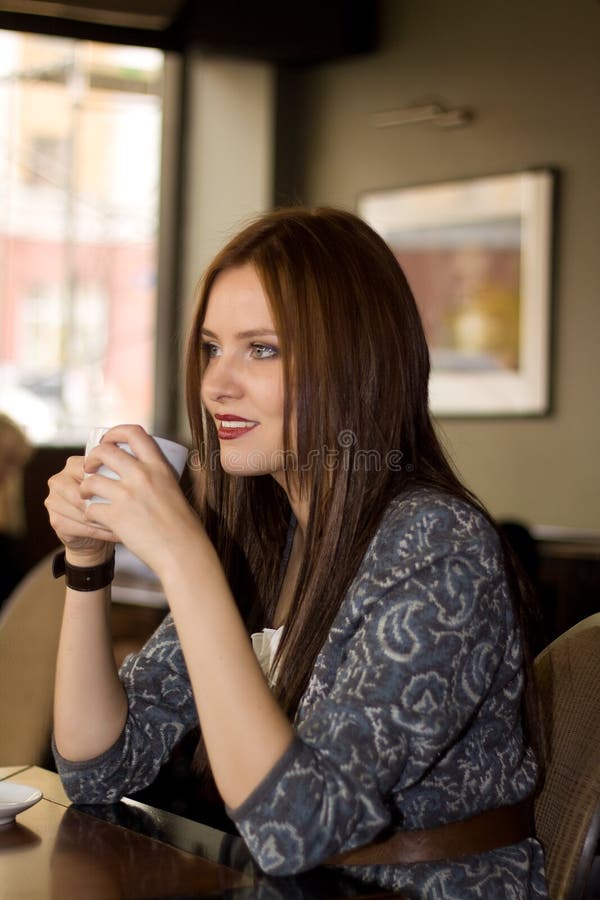 Young girl sipping coffee stock image. Image of gorgeous - 16741687