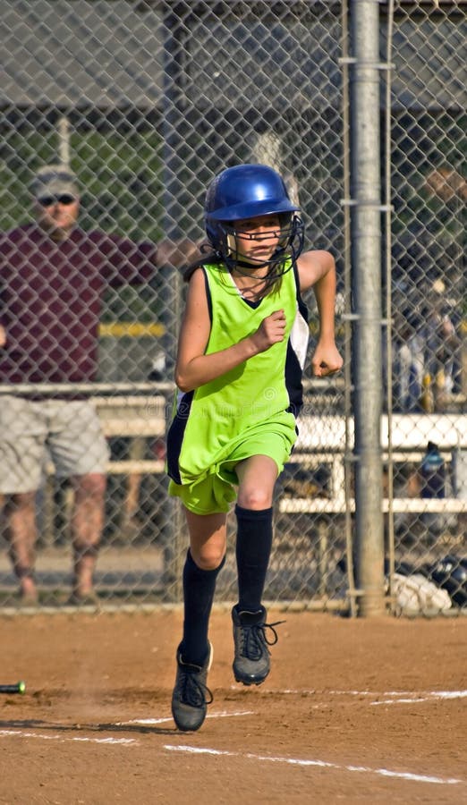 Young Girl Softball Player Running To First Base Stock Photo - Image of ...