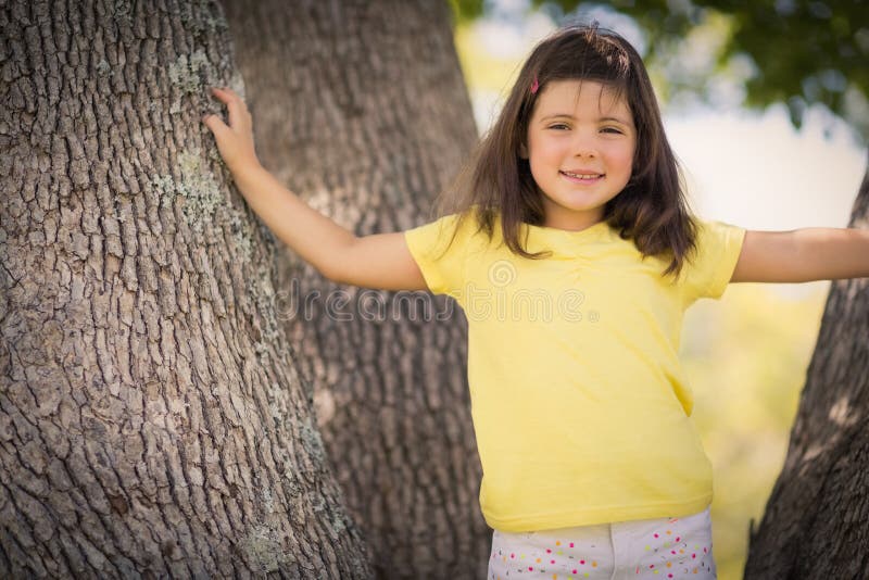 Young Girl Standing on Tree Trunk Stock Image - Image of pretty, casual ...