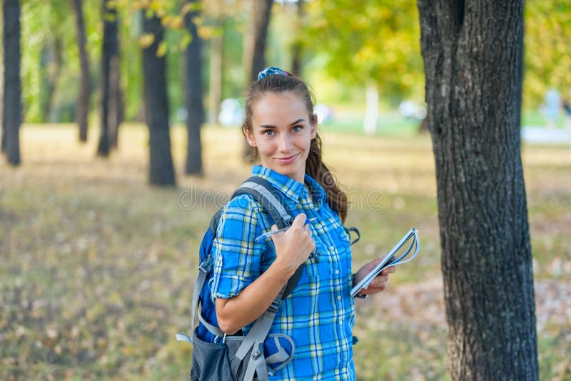 Young Girl Student with a Backpack and Notebook in Park Stock Image ...