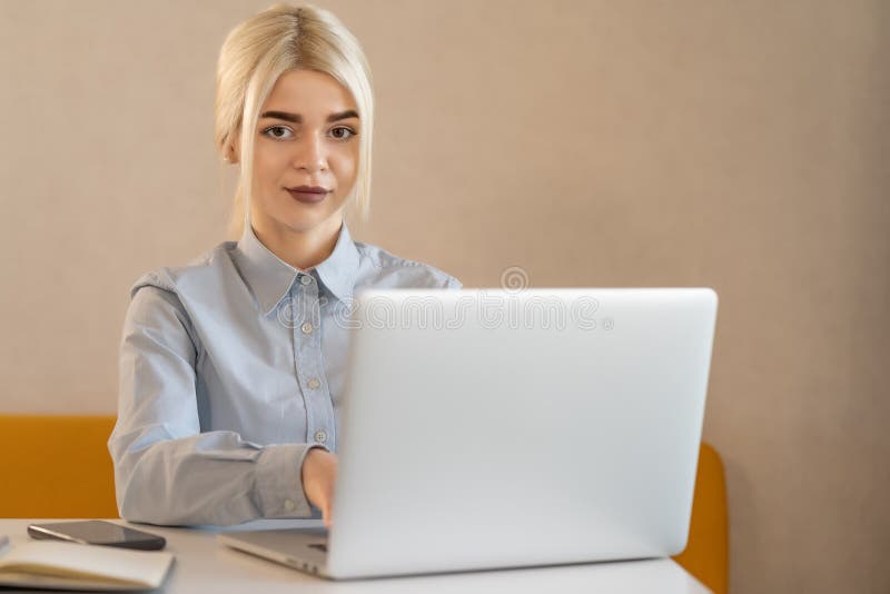 Young Girl Student or Office Worker at the Workplace Behind a Laptop ...