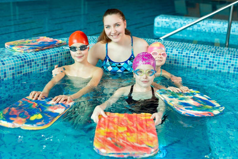 Young Girl Swimming Instructor with Children in the Pool. Stock Photo ...