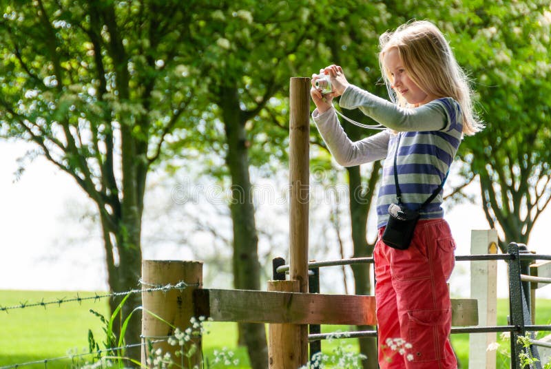 Young Girl Taking a Photo with a Point and Shoot Camera in a Rural ...