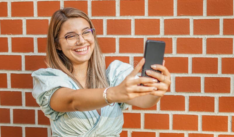 Young Girl Taking a Selfie - Smiling at the Camera - Happy Student ...