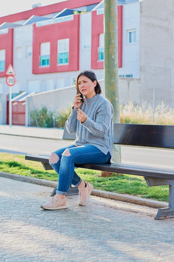 Young Girl Talking on Smartphone and Typing Messages with Smartphone ...