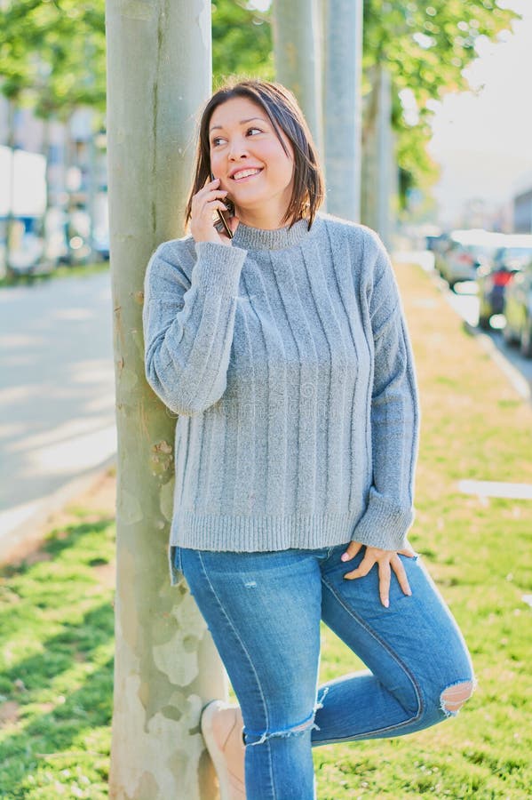 Young Girl Talking on Smartphone and Typing Messages with Smartphone ...