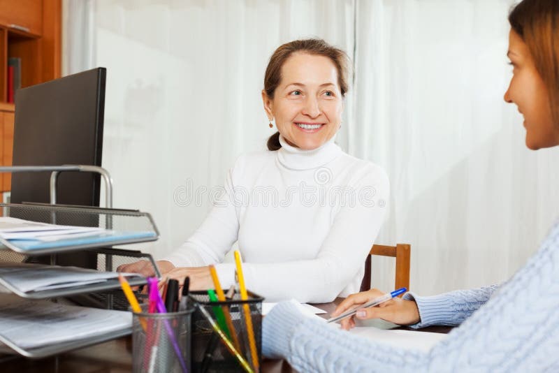 Young Girl Talking To Employee with Computer Stock Photo - Image of ...
