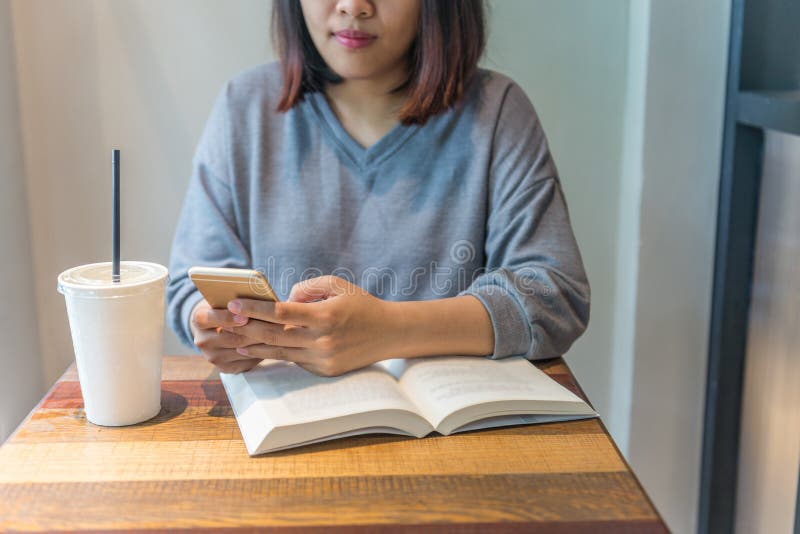 Young Girl Texting Message, Reading Book in the Library Stock Image ...