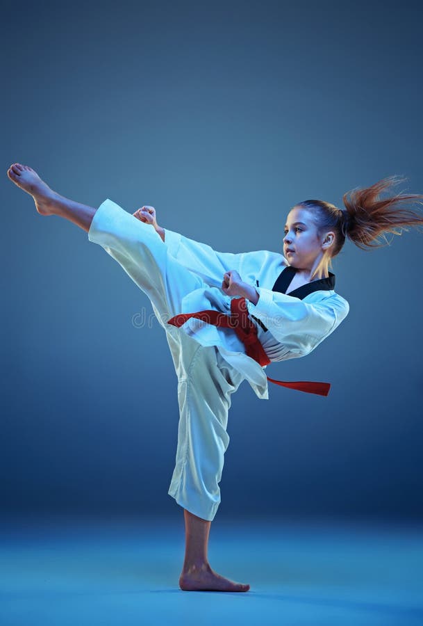 Young Girl Training Karate on Blue Background Stock Image - Image of ...