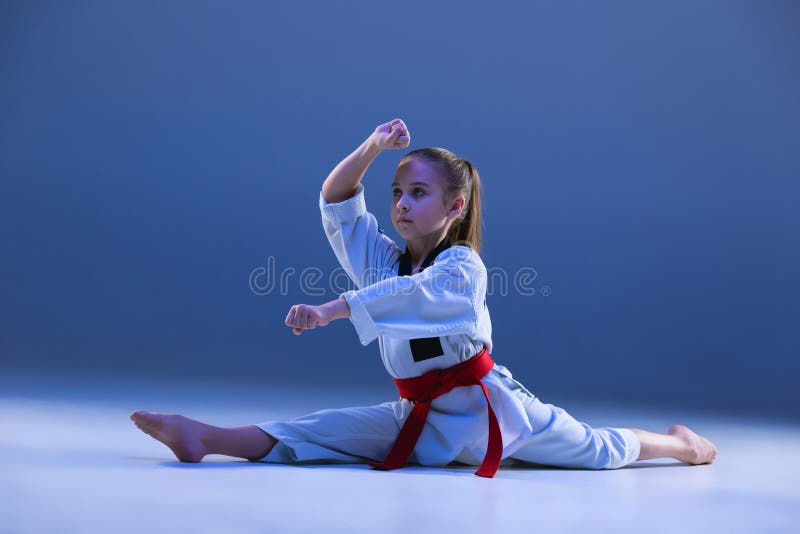 Young Girl Training Karate on Blue Background Stock Image - Image of ...