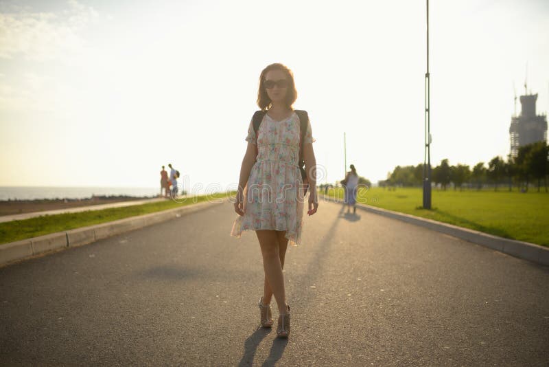 Young Girl the Traveler in a Dress and a Backpack Stock Photo - Image ...