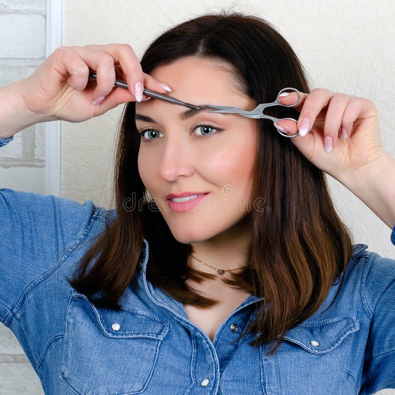 A Young Girl Trims Her Eyebrows with Special Manicure Scissors Stock ...