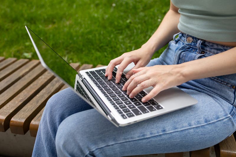 A Young Girl Types on the Keyboard of a Laptop, Computer. Stock Image ...