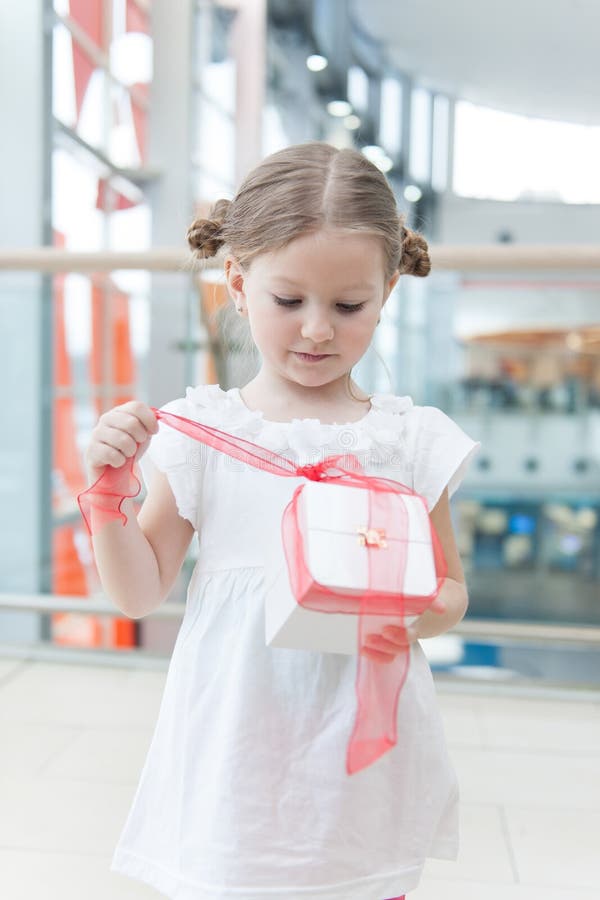 Young Girl Unwrapping Ribbon on Present Stock Image - Image of commerce ...