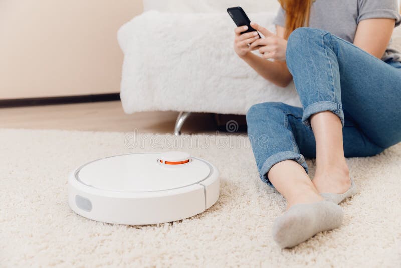 Young Girl Using Automatic Smart Robot Vacuum Cleaner Working on Carpet ...