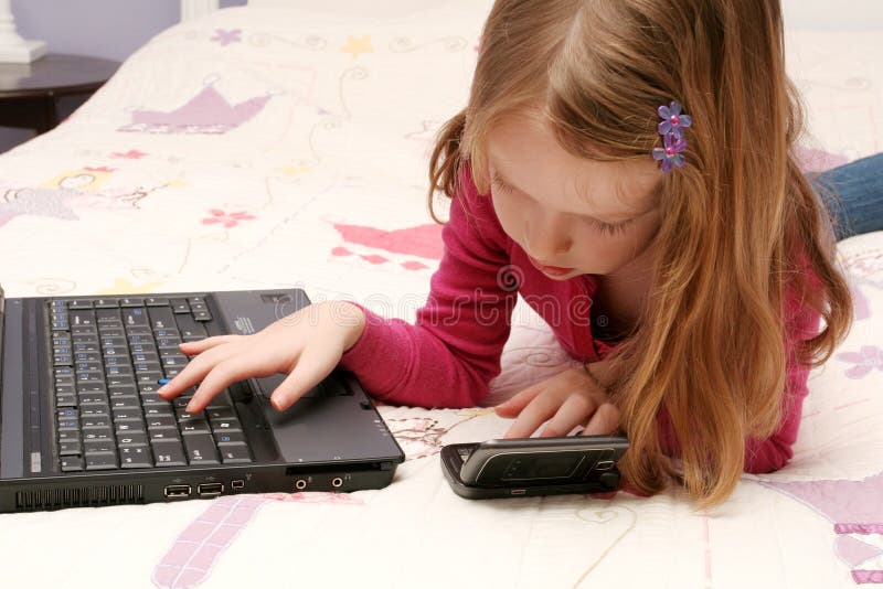 Young girl using a laptop stock image. Image of person - 12921515