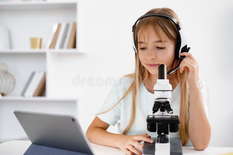 Young Girl Using Microscope during Online Lesson Education at Home ...