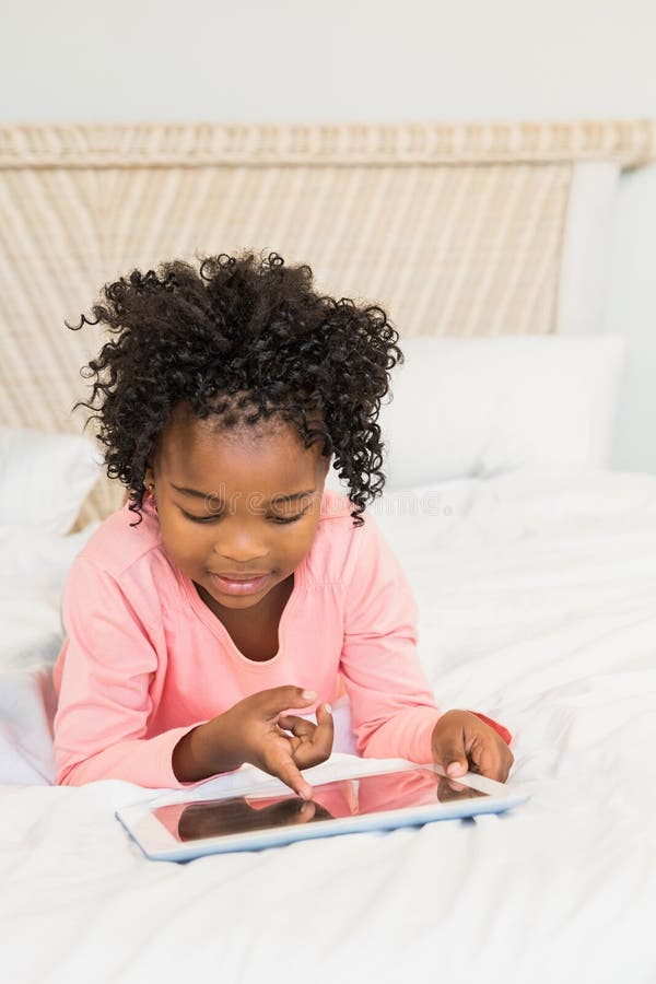 Young Girl Using Tablet on Bed Stock Photo - Image of person, casual ...