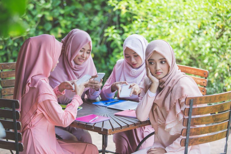 Young Girl Using Their Own Smartphone Ignoring Her Friend Stock Photos ...