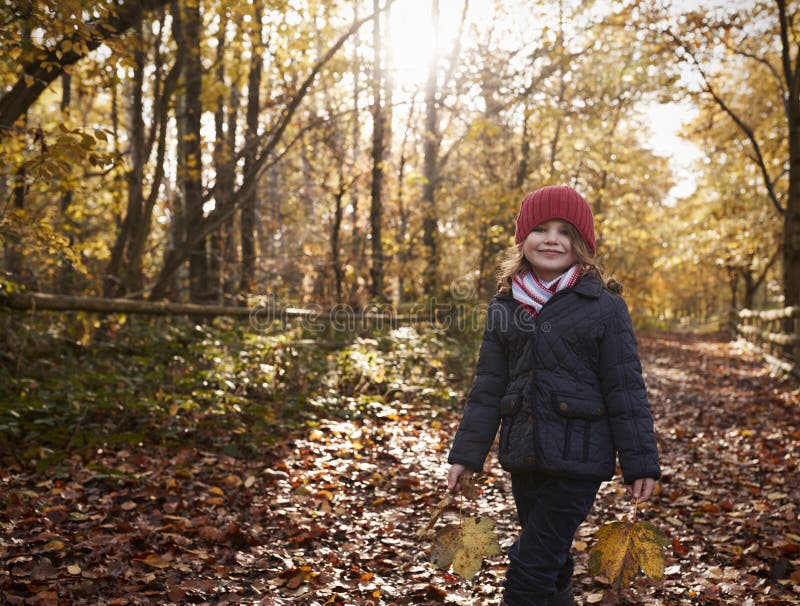 Young Girl Walking Along Path through Autumn Countryside Stock Photo ...